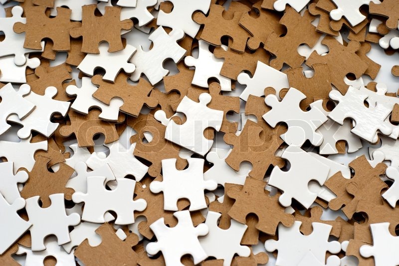 Heap of white and brown puzzle pieces | Stock image | Colourbox