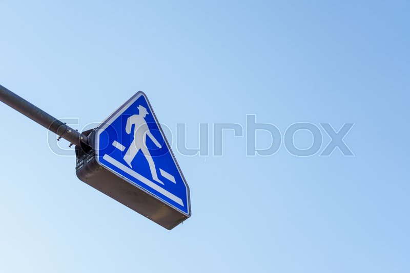 Blue triangle crosswalk sign above ... | Stock image | Colourbox
