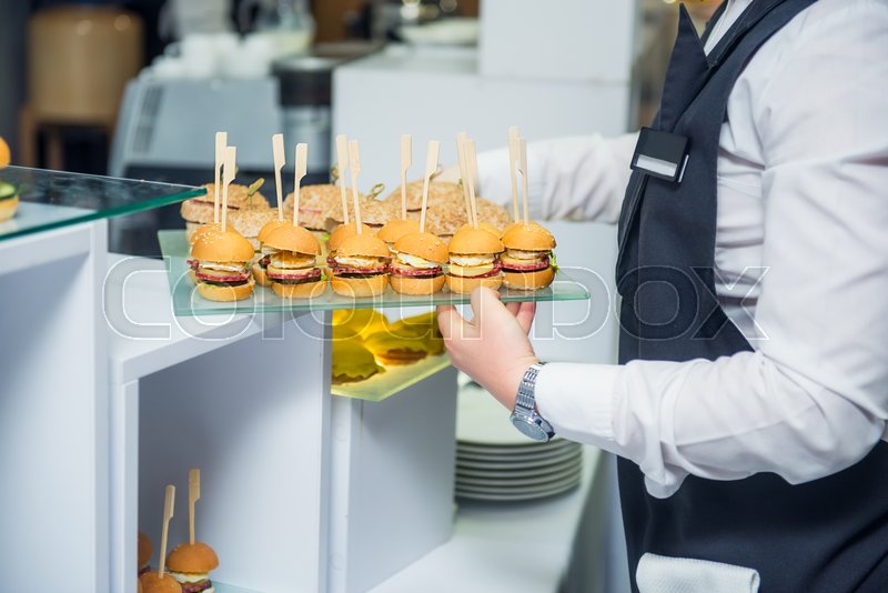 The waiter is servering catering buffet ... | Stock image | Colourbox
