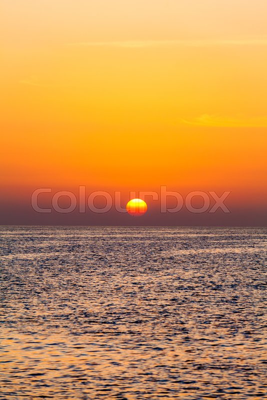 Sunset over ocean. Sunset on the beach ... | Stock image | Colourbox