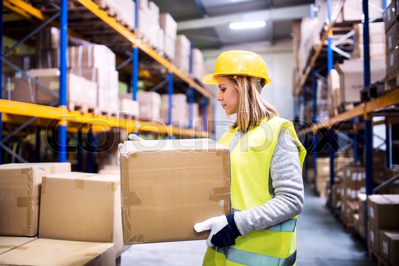 Young female warehouse worker loading ... | Stock image | Colourbox