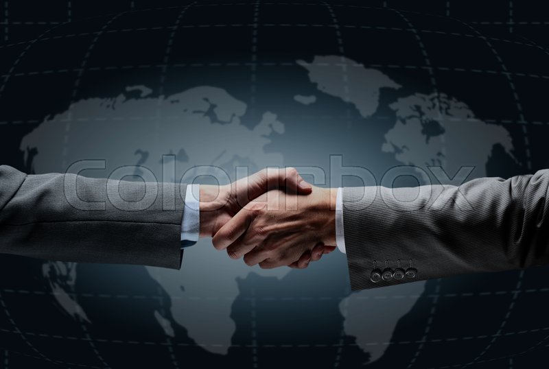Handshake with map of the world in ... | Stock image | Colourbox