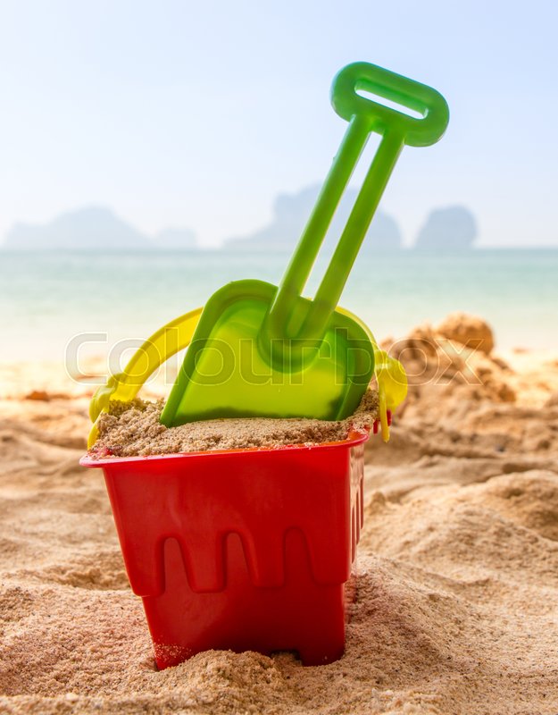 Bucket And Spade On A Sandy Beach Shows ... | Stock image | Colourbox