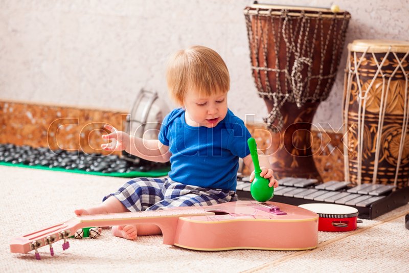 Little boy enthusiastically playing ... | Stock image | Colourbox