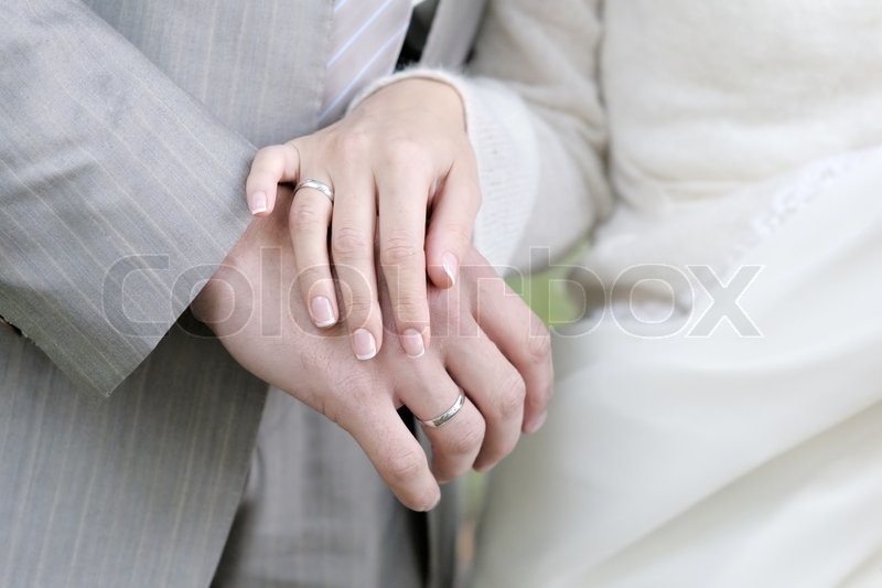 Bride and groom's hands with wedding ... | Stock image | Colourbox