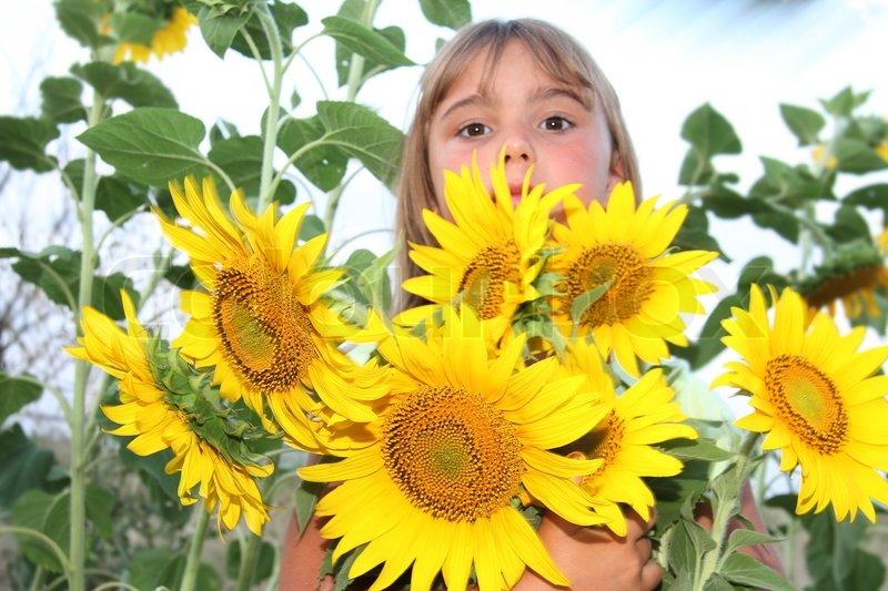 Child with flowers outdoors | Stock image | Colourbox