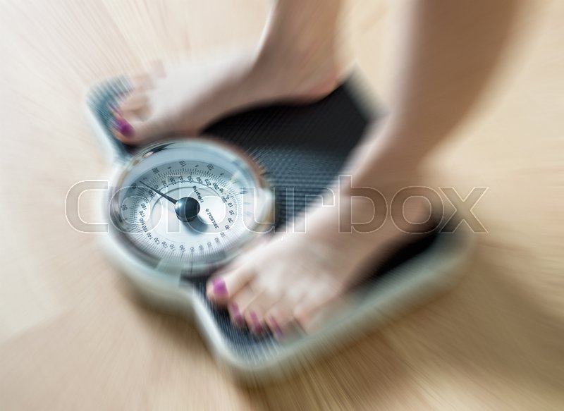 Female feet on scale with dramatic blur ... | Stock image | Colourbox