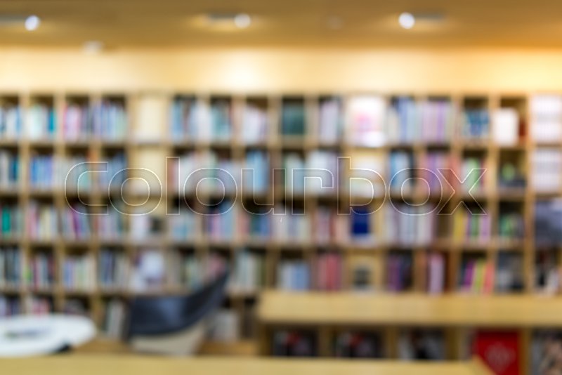 Blurred library with many books on ... | Stock image | Colourbox
