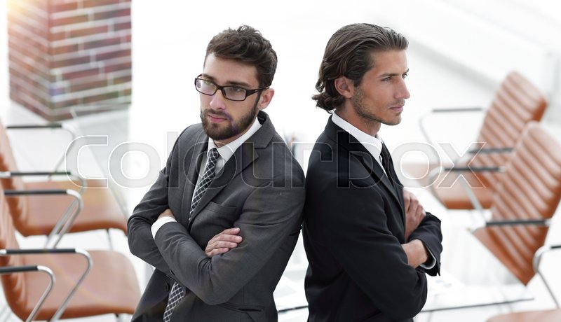 Two Men Standing Back To Back