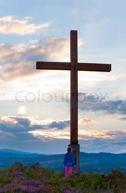 Small girl near wooden cross on summer ... | Stock image | Colourbox