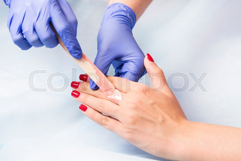The process of classical wax depilation ... | Stock image | Colourbox