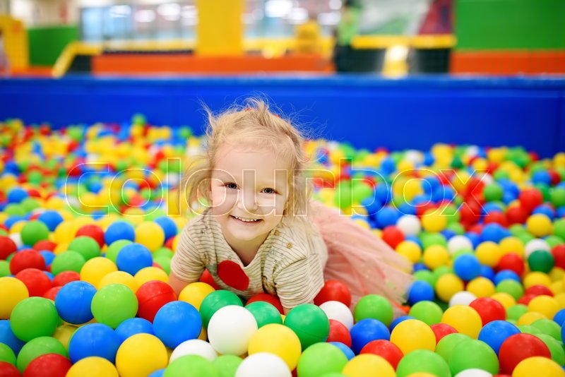 Curly little girl having fun in ball ... | Stock image | Colourbox