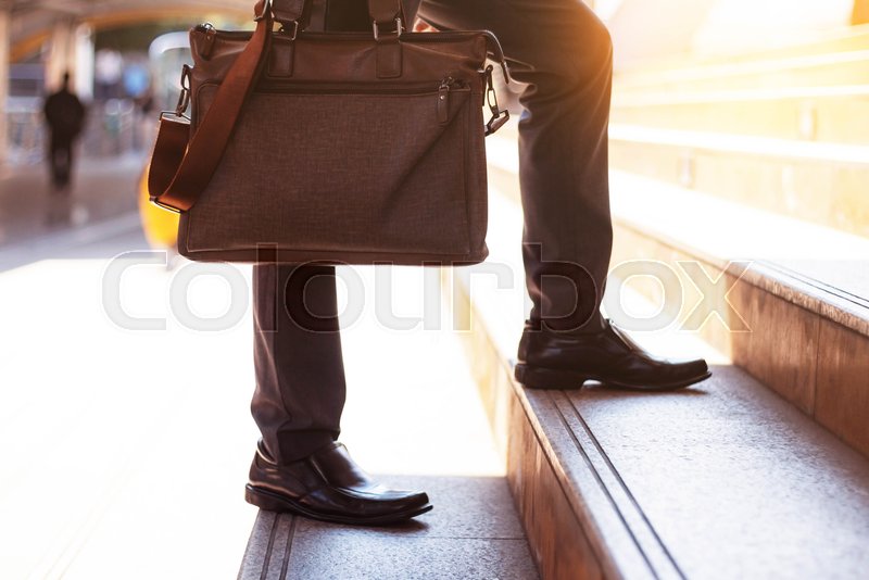 Businessman carrying a bag to work in ... | Stock image | Colourbox