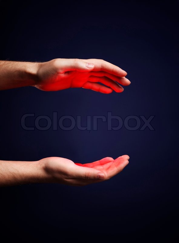 Hands of a man with a red glow | Stock image | Colourbox