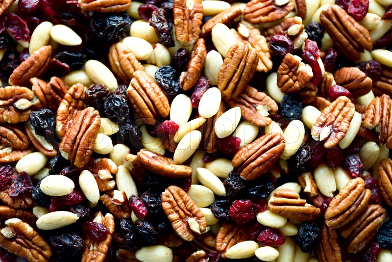 Mixed nuts and raisins in wooden bowl. ... | Stock image | Colourbox