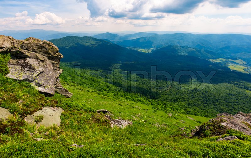 Rocky cliff over the grassy valley. ... | Stock image | Colourbox