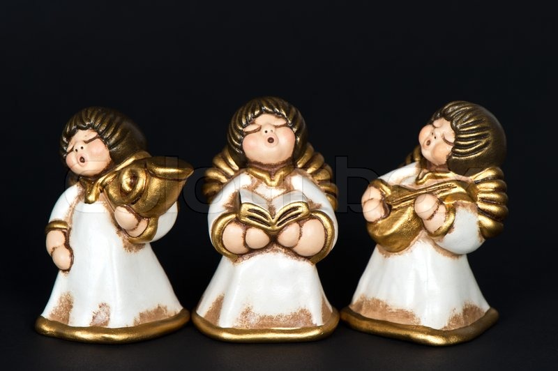 Cute singing angels on black background | Stock image | Colourbox