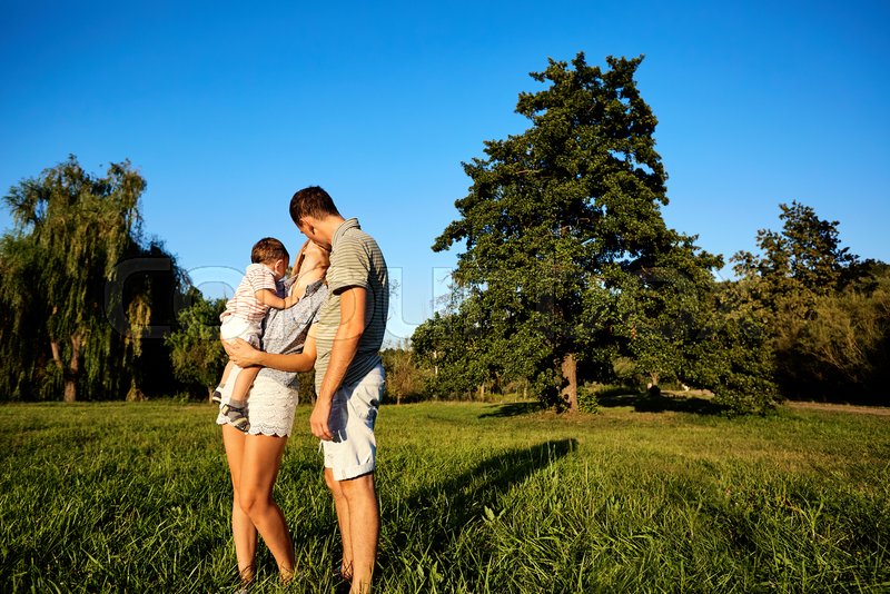 Happy family in nature. Parents with a ... | Stock image | Colourbox