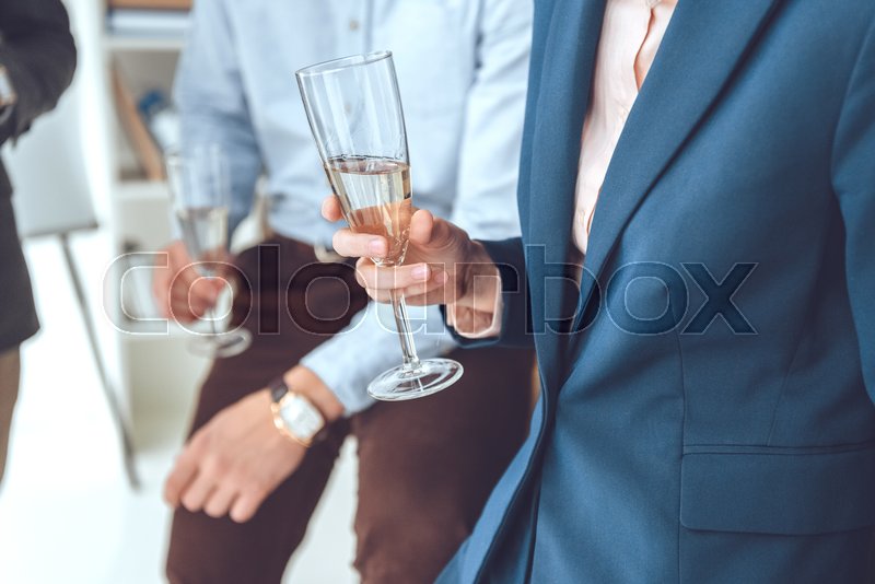Cropped image of men holding glasses in ... | Stock image | Colourbox