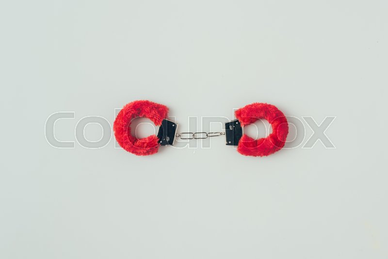 Top view of locked red fluffy handcuffs ... | Stock image | Colourbox