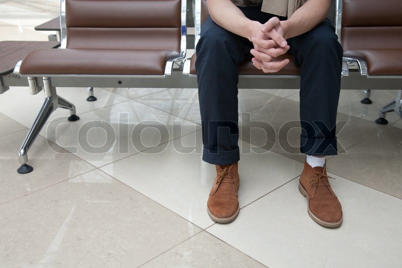 Man sitting in a waiting room with ... | Stock image | Colourbox