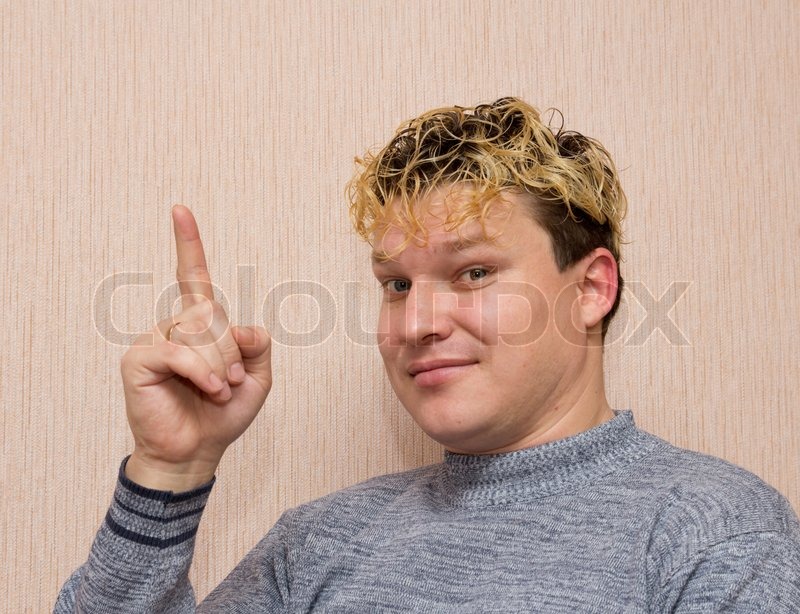 Portrait of a man raise a finger up | Stock image | Colourbox
