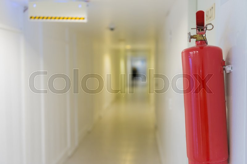 Fire extinguisher in front of room at ... | Stock image | Colourbox