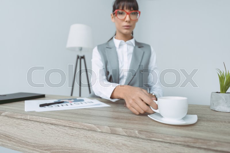 Businesswoman taking cup of coffee at ... | Stock image | Colourbox