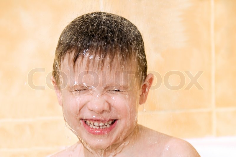 A smiling child washing in the shower | Stock image | Colourbox