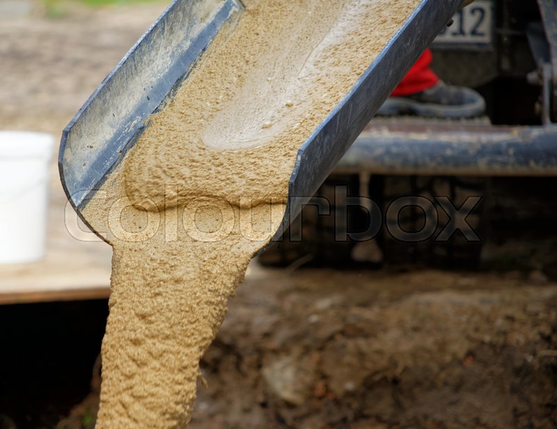 Liquid soil is poured from the ramp of ... | Stock image | Colourbox