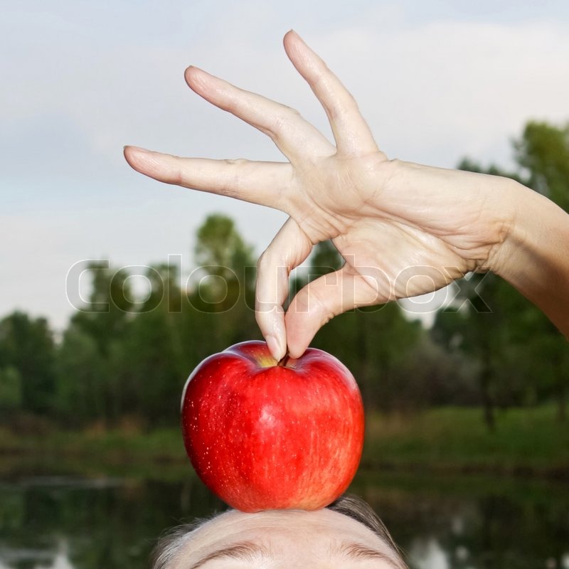 Ladies fingers hold apple on her ... | Stock image | Colourbox