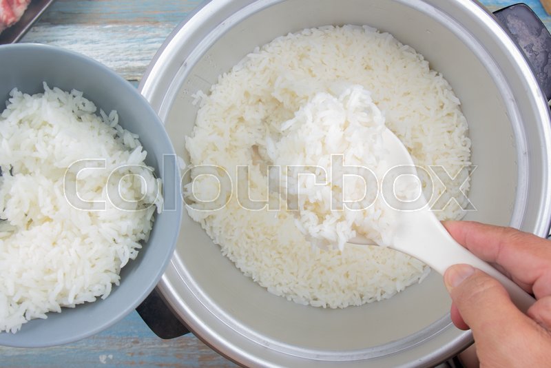 Chef put cooked rice with plastic ladle ... | Stock image | Colourbox