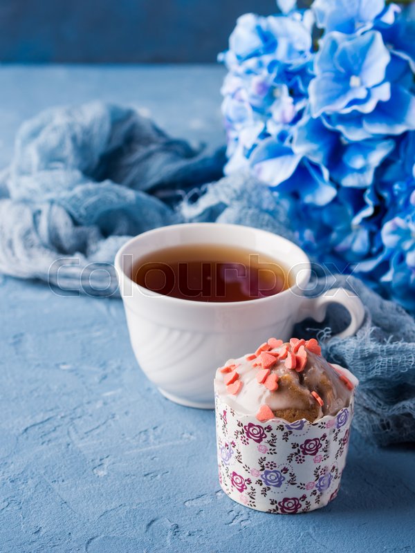 Cup of tea on blue background with ... | Stock image | Colourbox