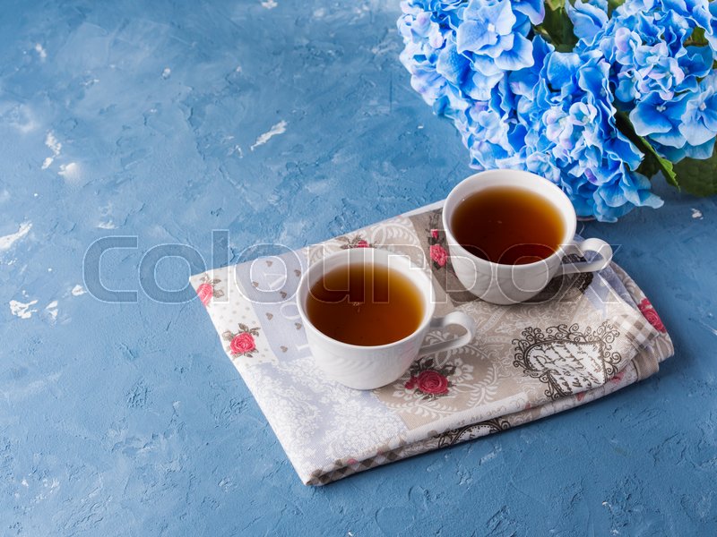 Cup of tea on blue background with ... | Stock image | Colourbox