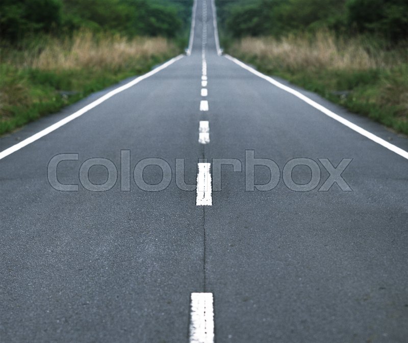 Straight tar road leading into the ... | Stock image | Colourbox