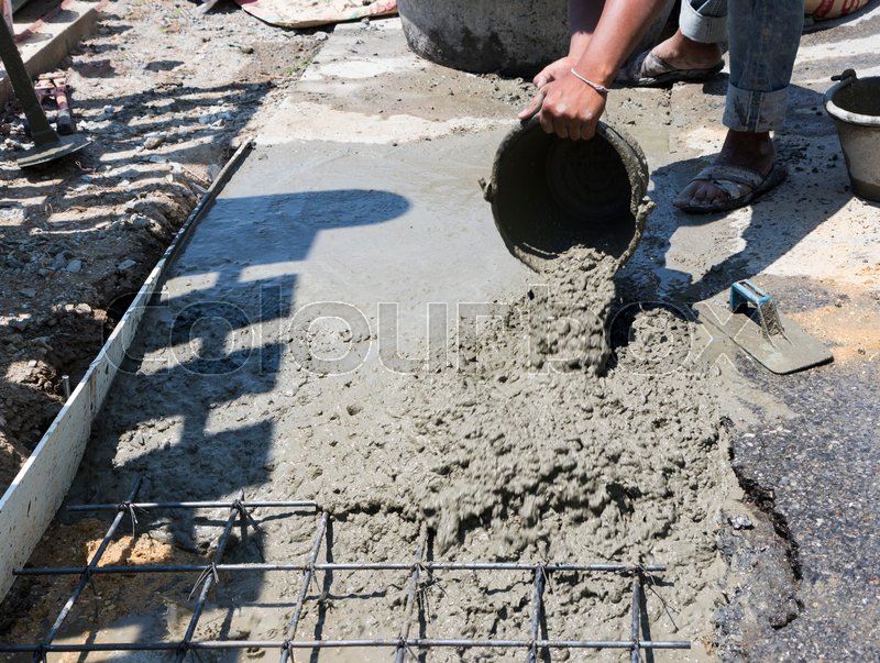 Worker pour concrete into wire mesh ... | Stock image | Colourbox