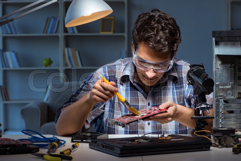Computer repair man cleaning dust with ... | Stock image | Colourbox