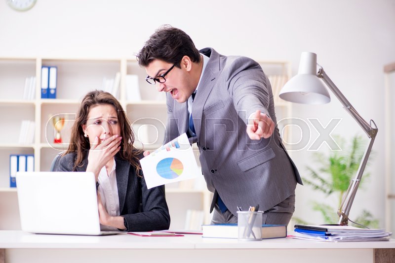 Angry boss unhappy with female employee ... | Stock image | Colourbox