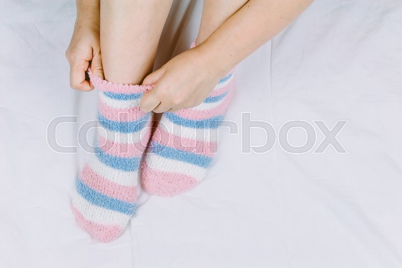 Woman hands putting on socks | Stock image | Colourbox