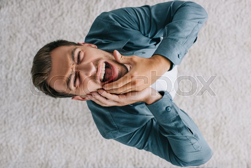 Overhead view of young man screaming ... | Stock image | Colourbox
