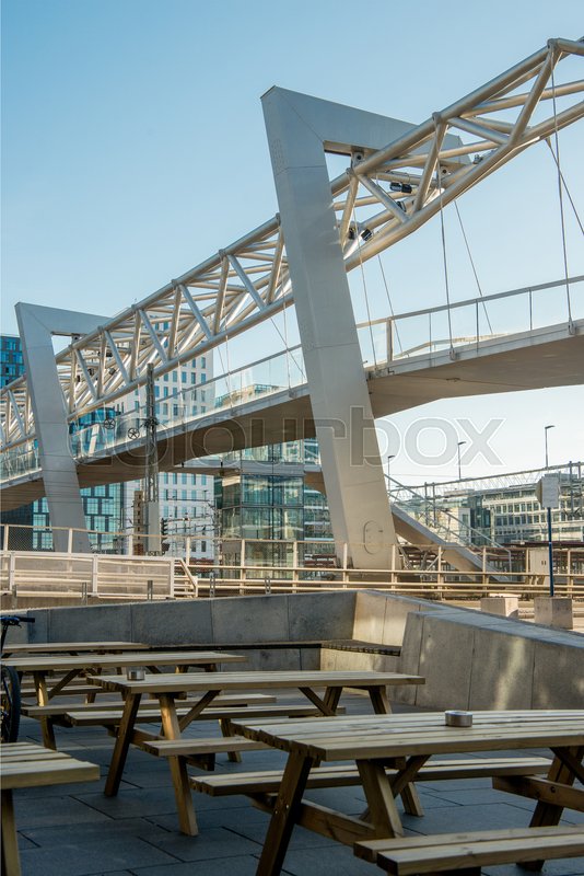 Wooden tables and benches near bridge ... | Stock image | Colourbox