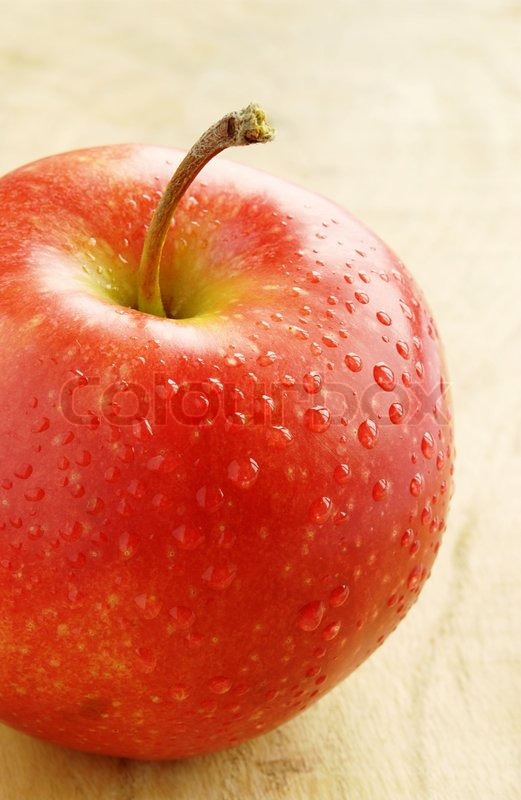 One large apple with drops of dew on ... | Stock image | Colourbox
