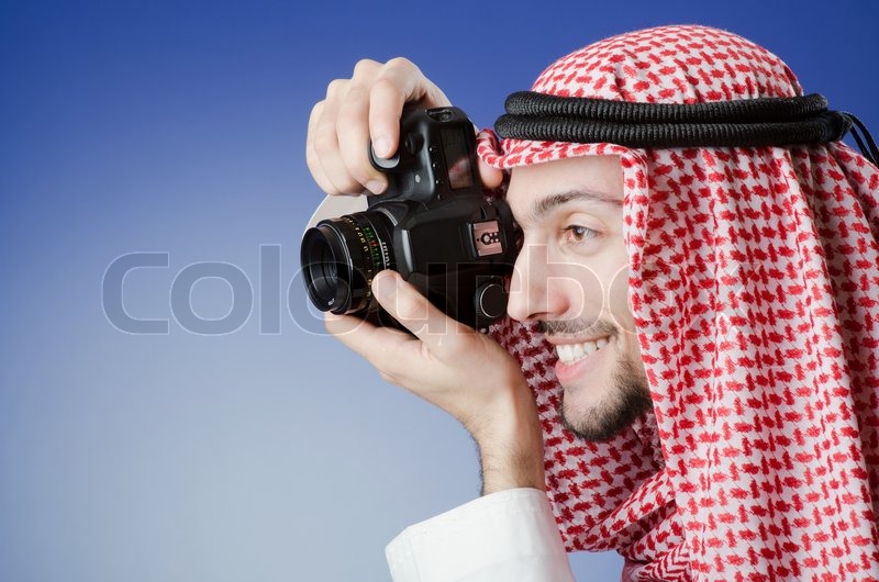 Arab photographer in studio shooting | Stock image | Colourbox
