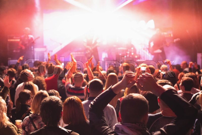 A concert crowd of people applauds the ... | Stock image | Colourbox