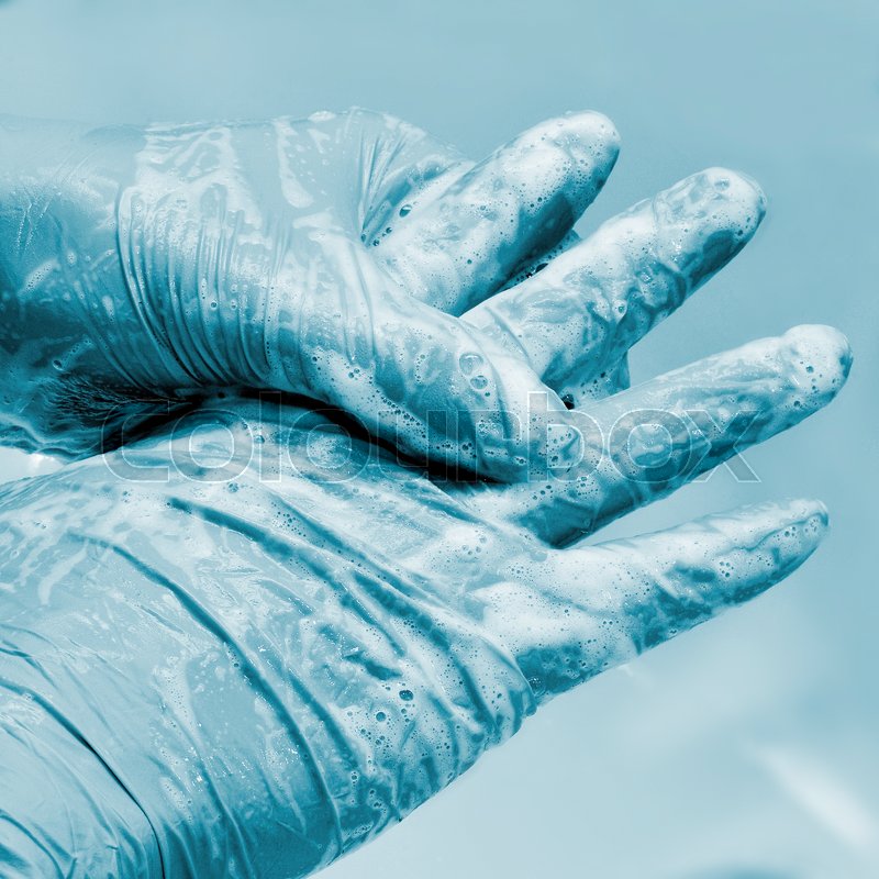 Someone wearing surgical gloves washing ... | Stock image | Colourbox