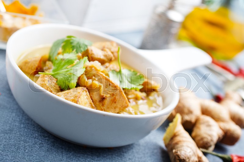 Chicken curry in white bowl on a table | Stock image | Colourbox