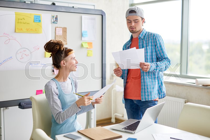 Two students with papers preparing for ... | Stock image | Colourbox