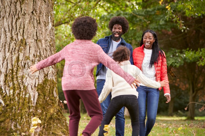 Two kids jumping out from behind a tree ... | Stock image | Colourbox