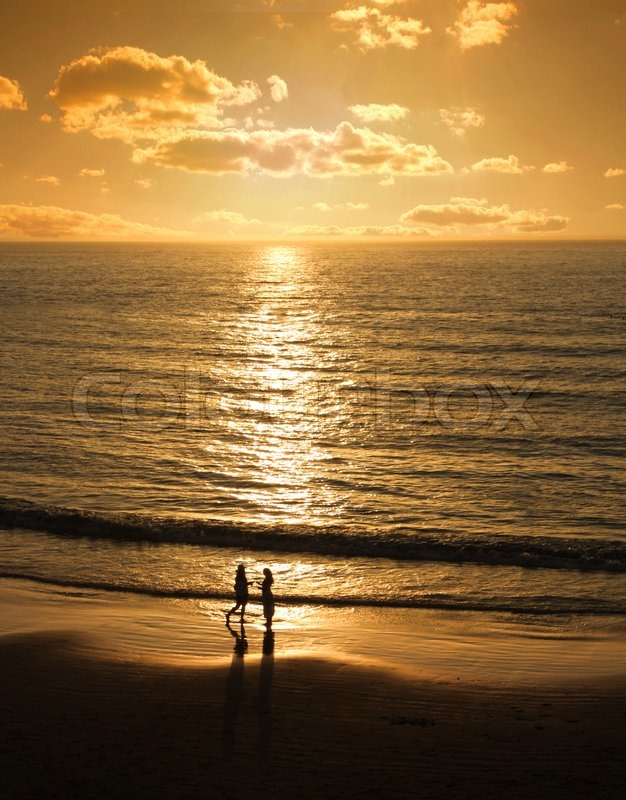 Couple meets at sunset beach | Stock image | Colourbox