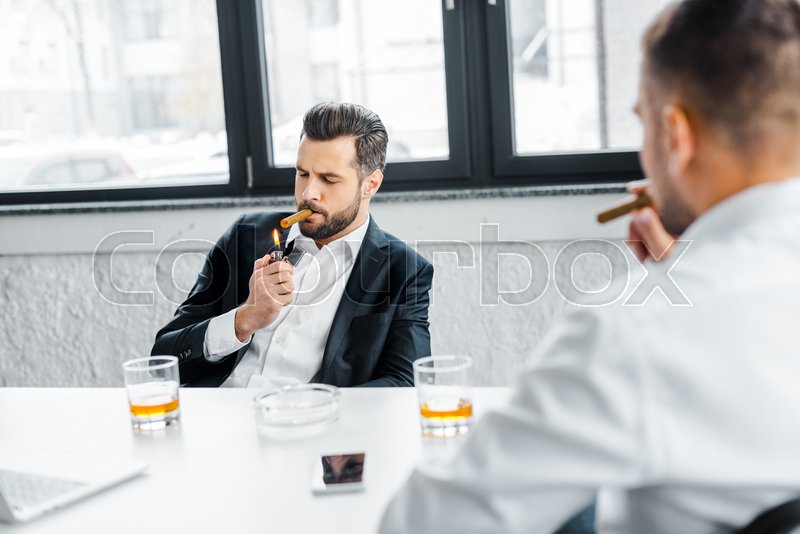 Businessmen in formal wear smoking ... | Stock image | Colourbox